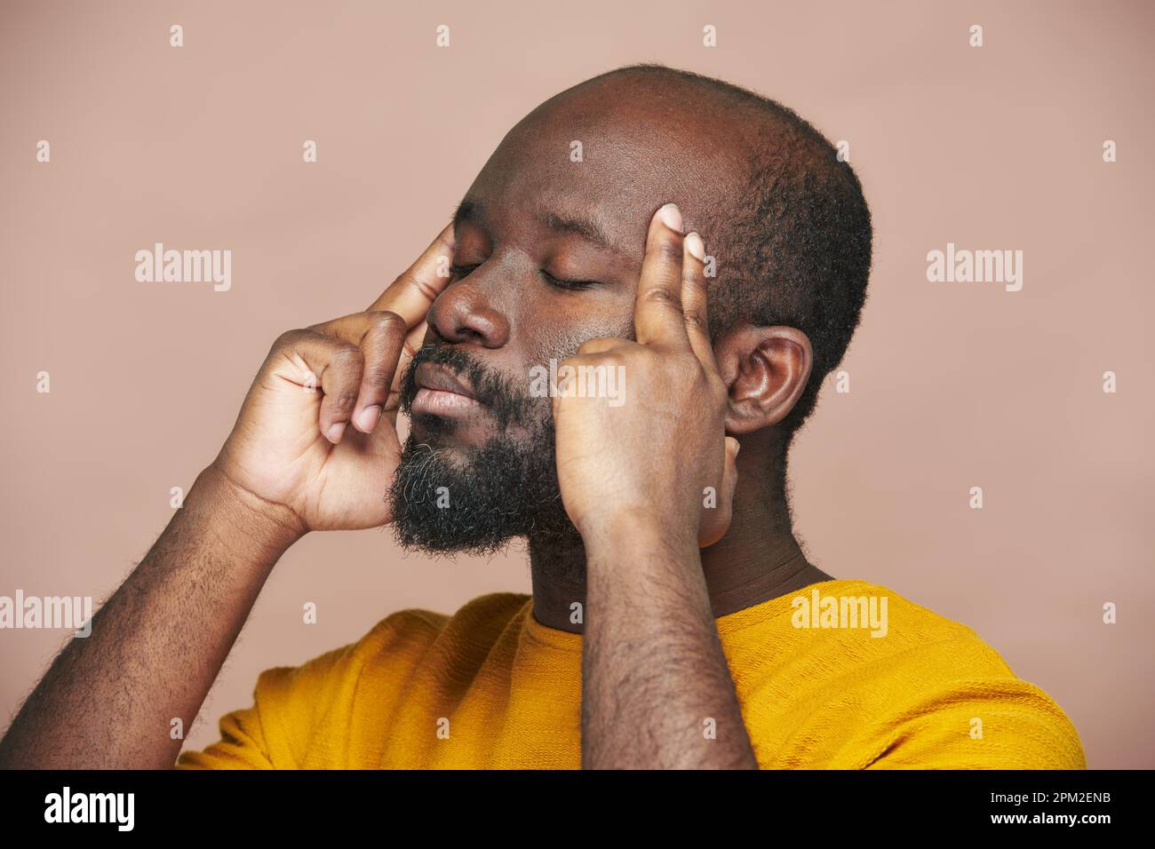 African American man concentrating with his eyes closed and thinking ...