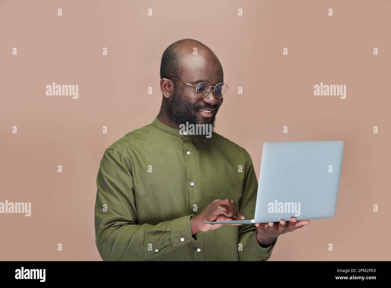 Positive bald african man typing hi-res stock photography and images ...