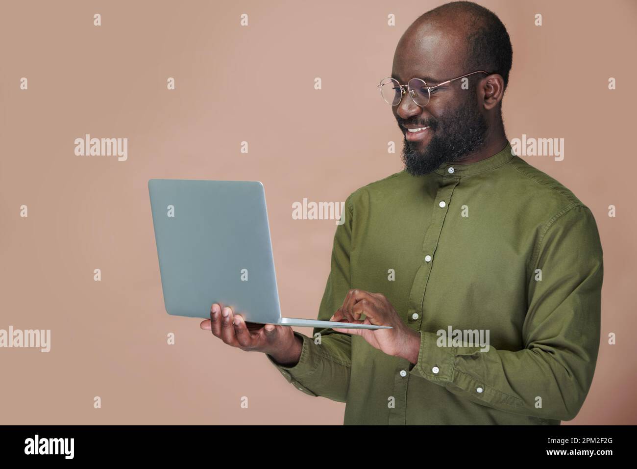 Positive bald african man typing hi-res stock photography and images ...