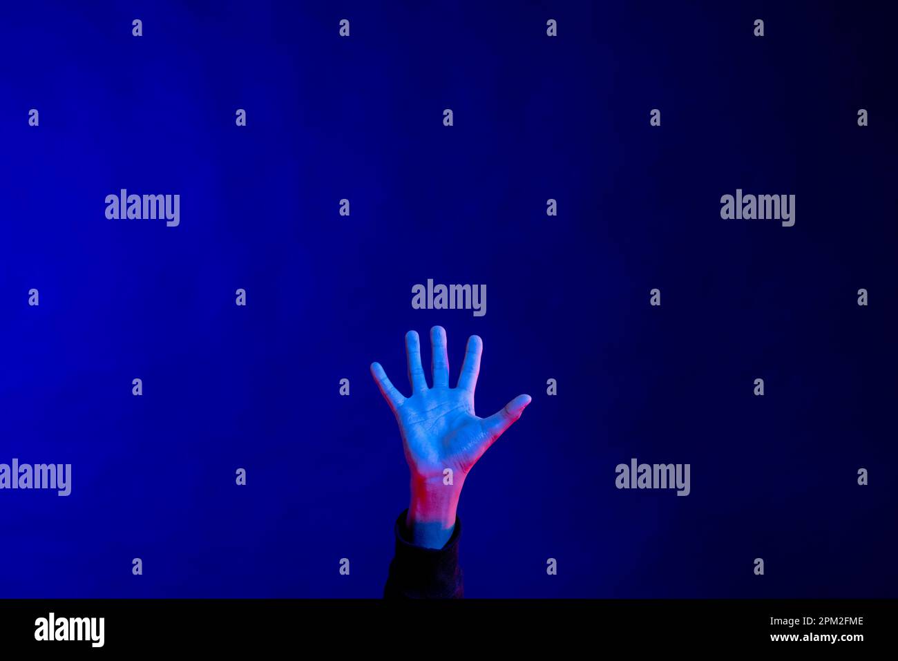 Exposed open hand in studio with blue light with copy space Stock Photo ...