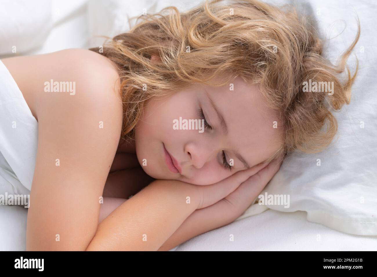 Kid sleeping in cozy white bed. Little kid sleeps on bed, napping. Cute ...