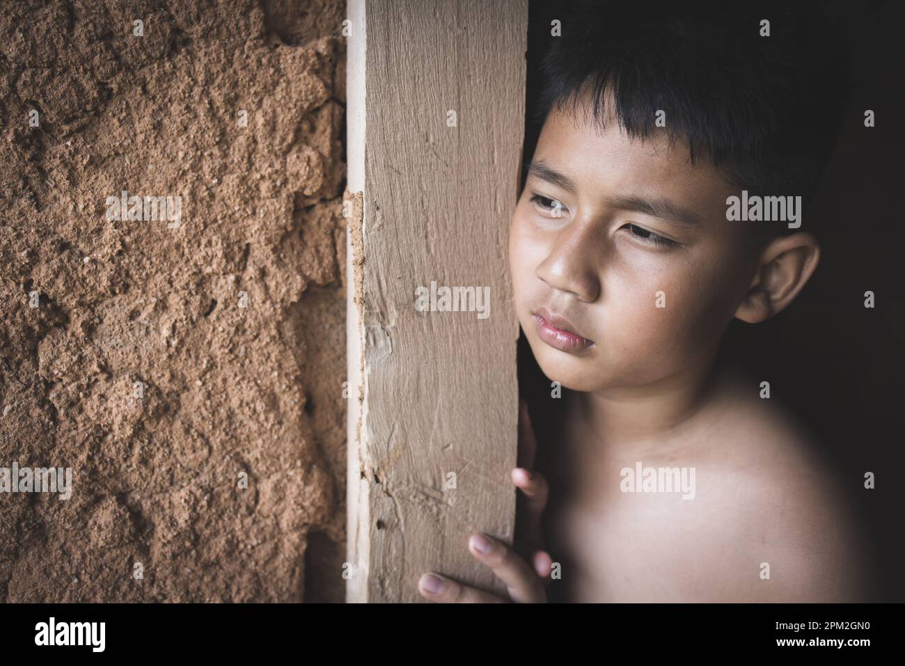 Portrait of a poor little thailand boy lost in deep thoughts, poverty ...