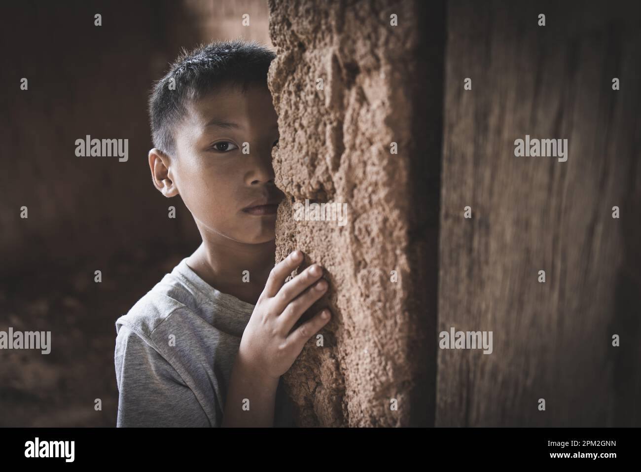 Portrait of a poor little thailand boy lost in deep thoughts, poverty ...