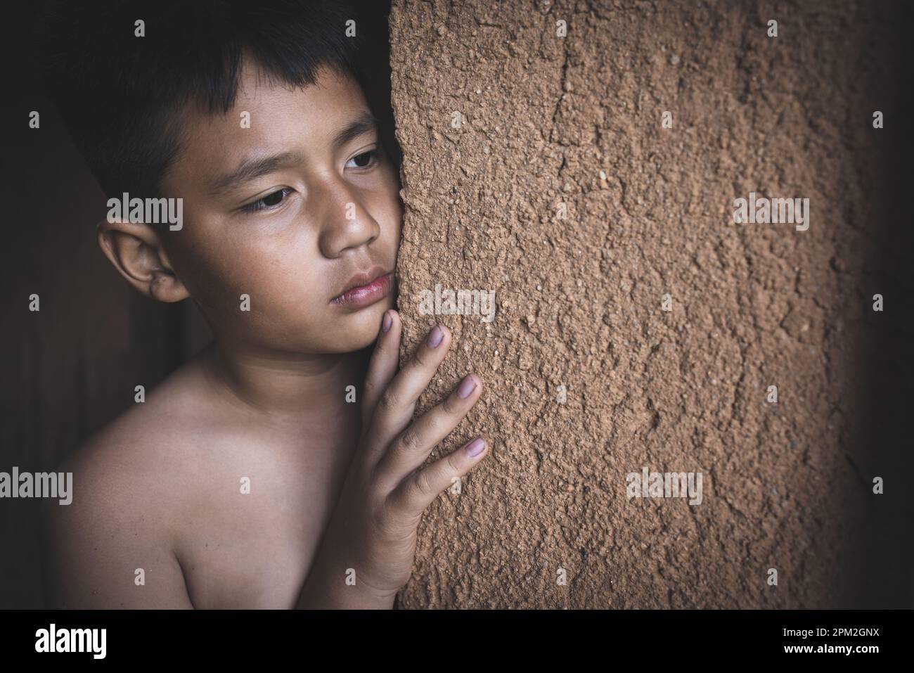 Portrait of a poor little thailand boy lost in deep thoughts, poverty ...