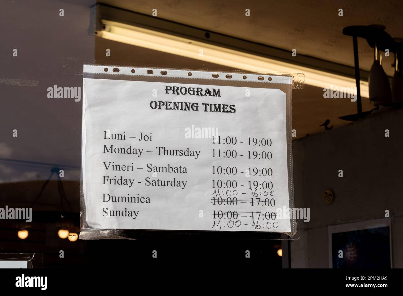 Dual language (Polish and English) opening time sign for a Polish shop ...