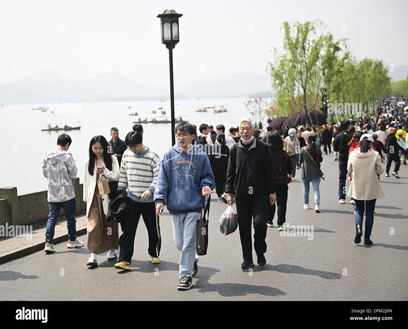 Tourists enjoy spring scenery at West Lake scenic area in Hangzhou City ...