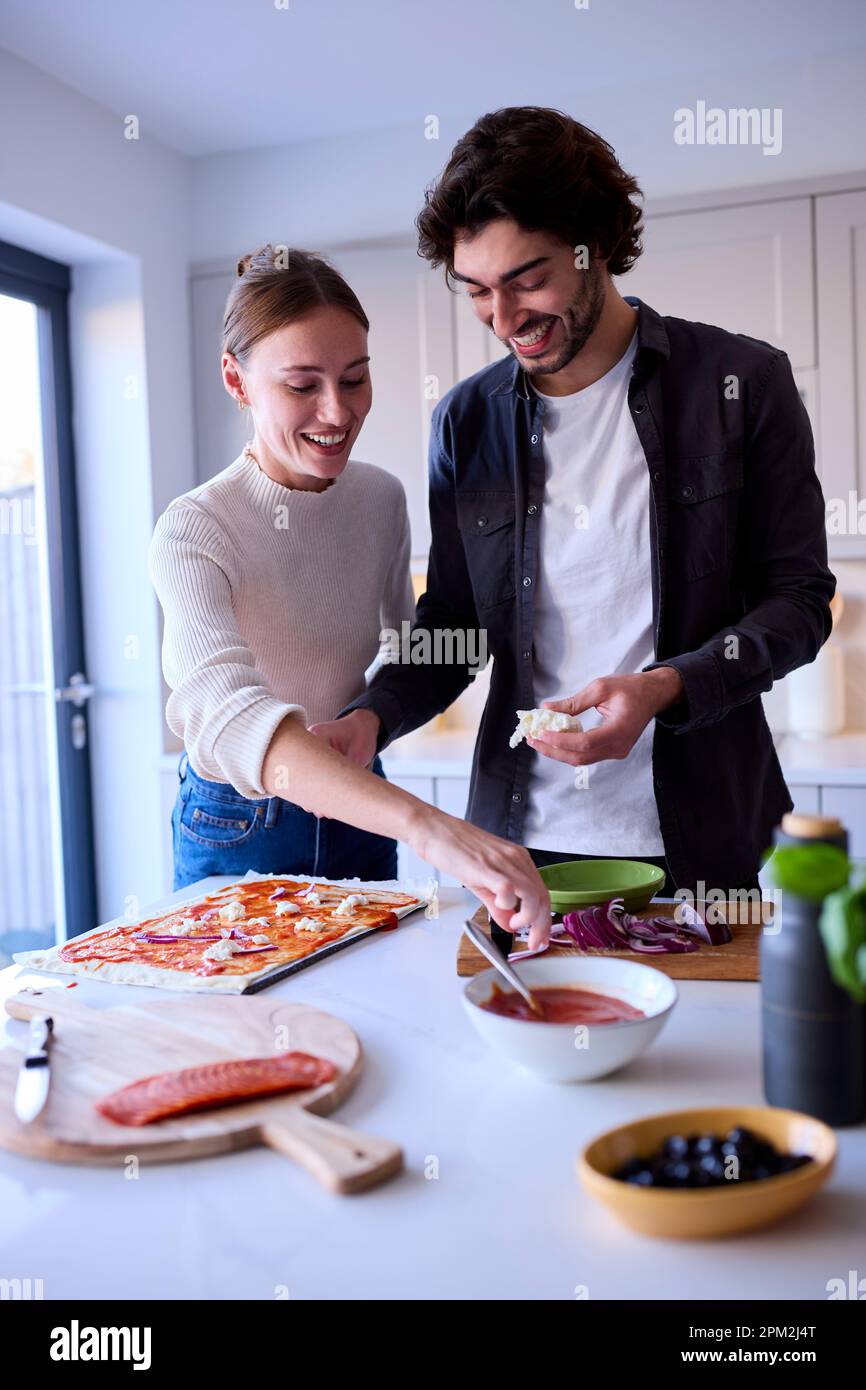 Happy couple making pizza hi-res stock photography and images - Alamy