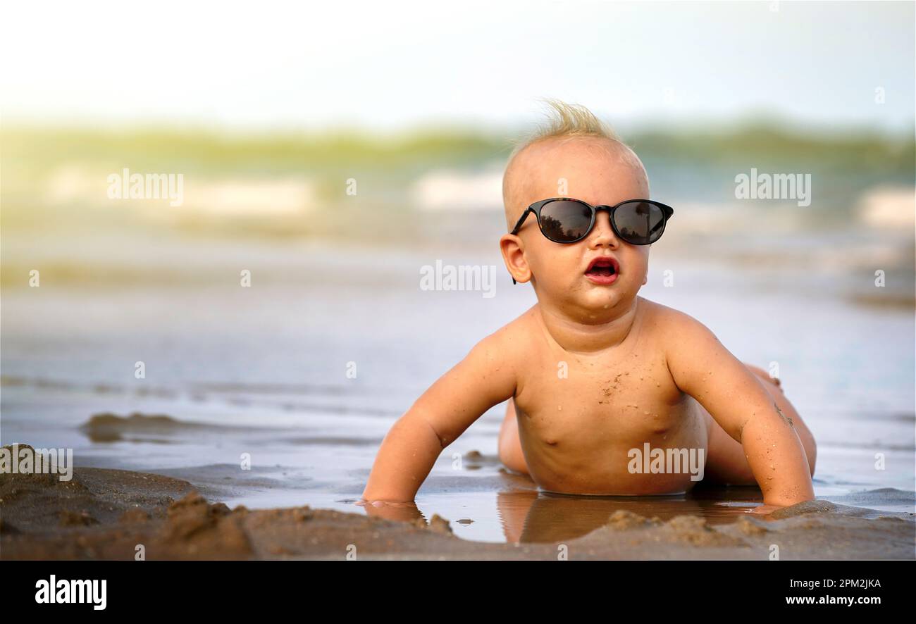 Baby lying in the sun hi-res stock photography and images - Alamy