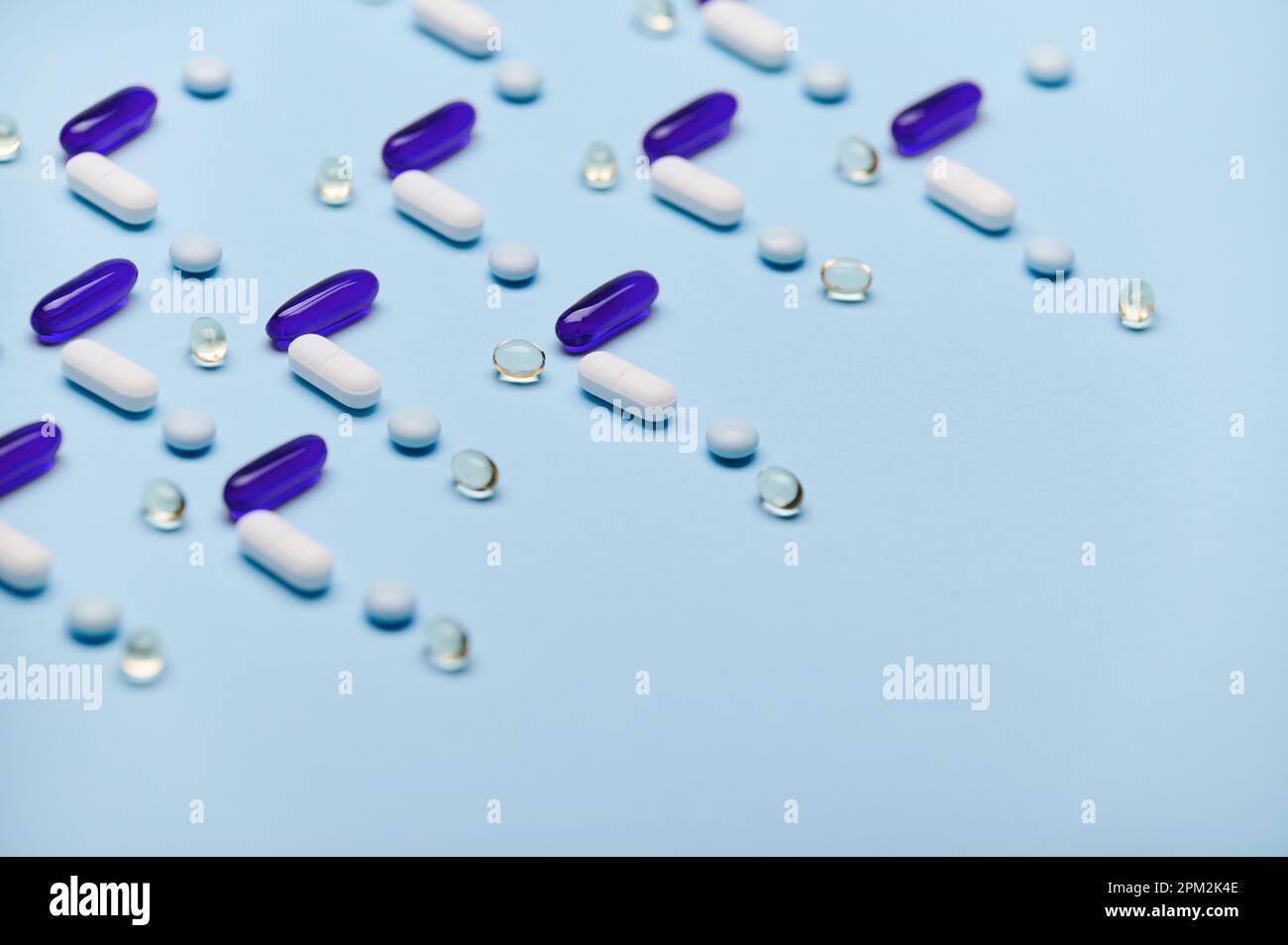 Layout with blue gel translucent capsules, dragees, medical pills ...