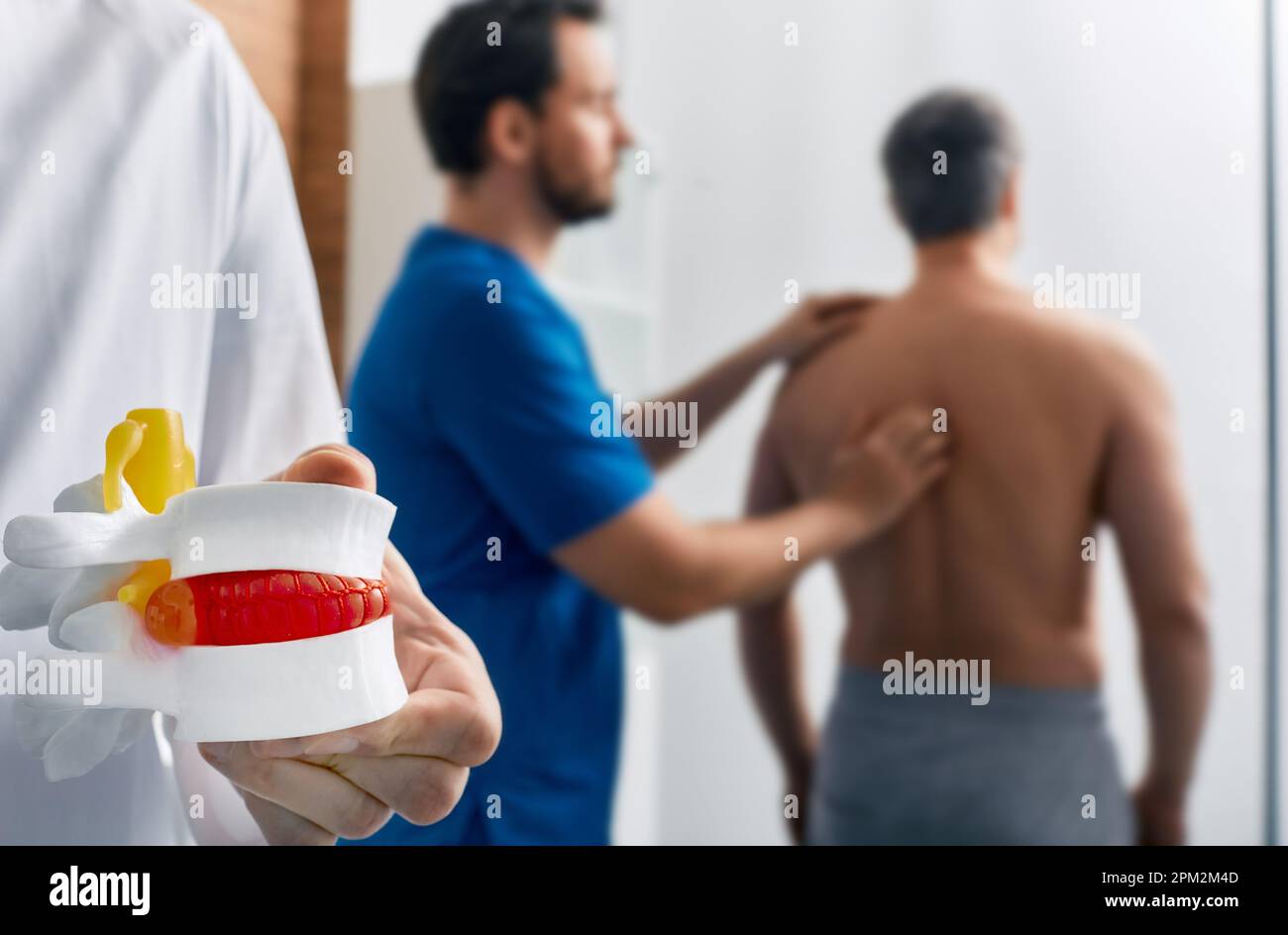 Man with acute back pain at chiropractor consultation with preliminary ...