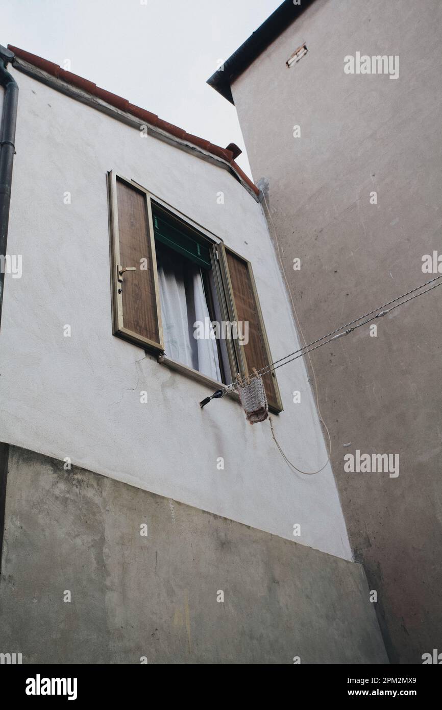 A modern building with pristine white walls and a single window on the ...