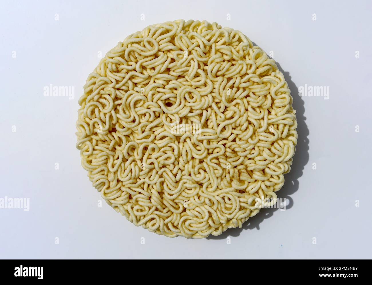 Raw instant noodles on white background - round instant noodles Stock ...