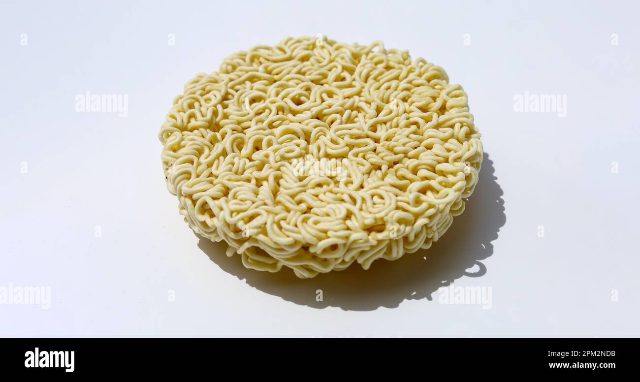 Raw instant noodles on white background - round instant noodles Stock ...