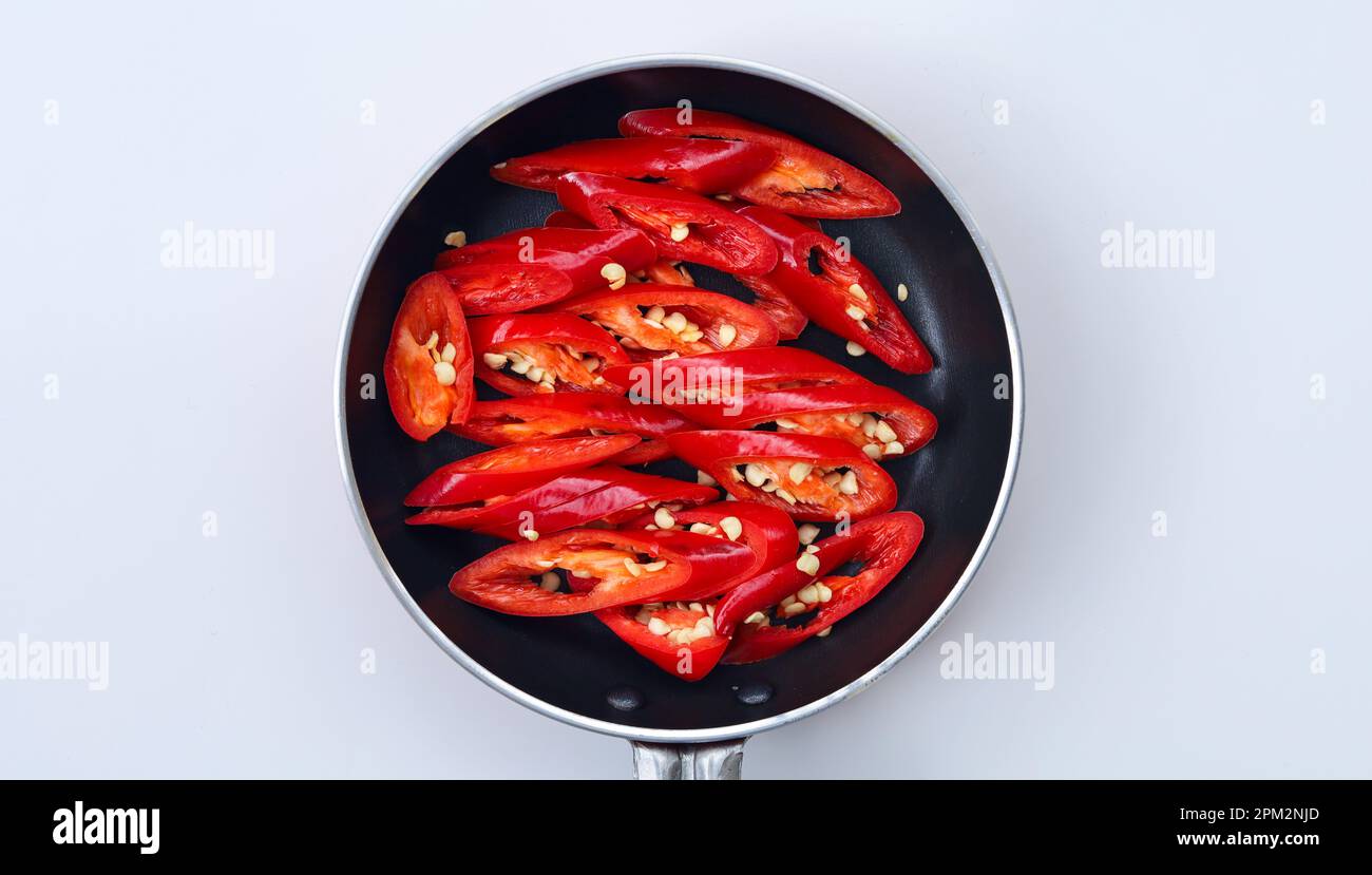 Top view, red hot chili chopped on frying pan Stock Photo - Alamy