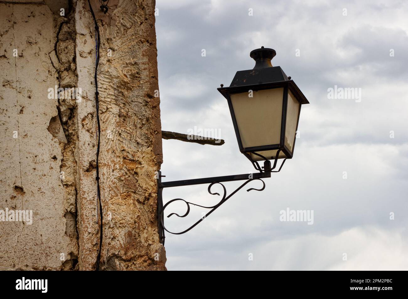Street lamp typical of village during the day on cloudy sky Stock Photo ...