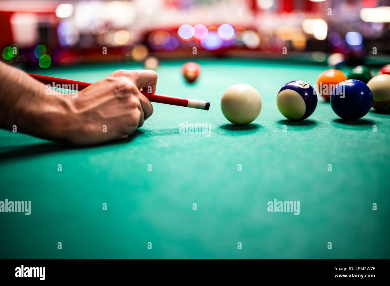 Young man playing snooker, aiming. for a good shot Stock Photo - Alamy