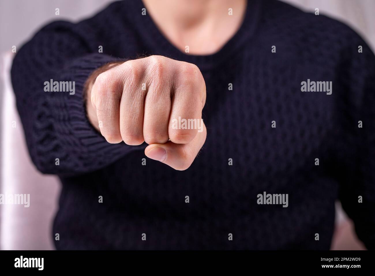 Man making fist by clenching his hand towards camera. close up Stock ...