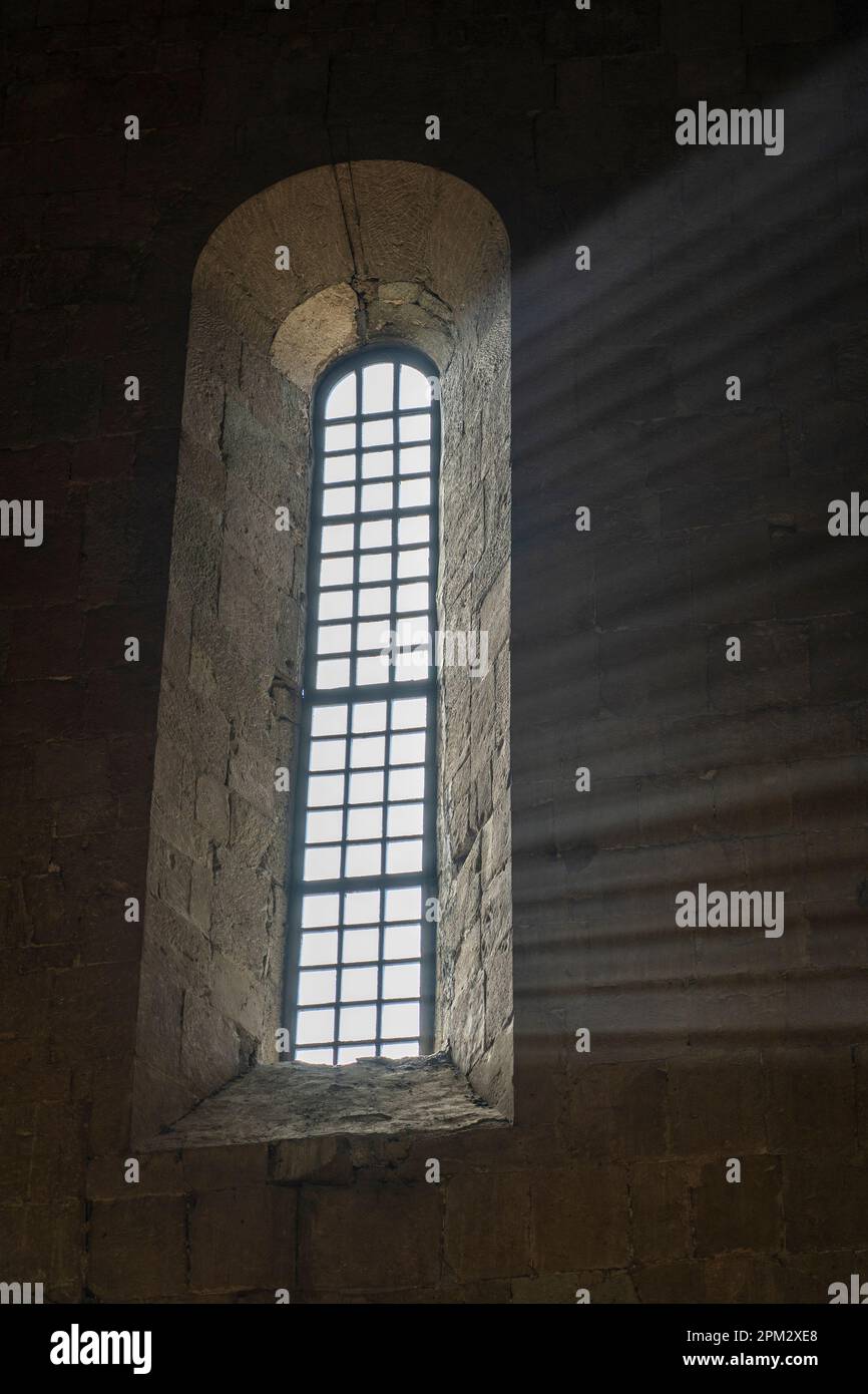 Sunlight penetrates through the arched window in the old orthodox ...
