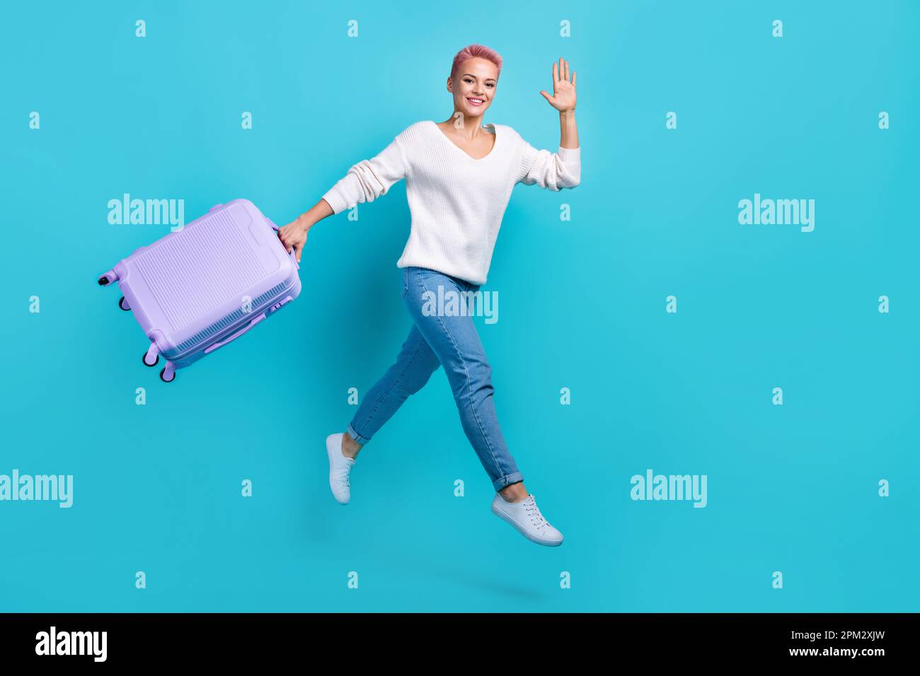 Full length carefree traveler girl hold baggage airport young lady show ...