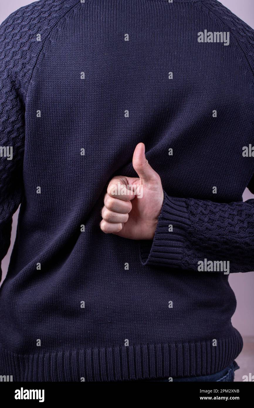 Man making an approval sign on his back from behind Stock Photo - Alamy