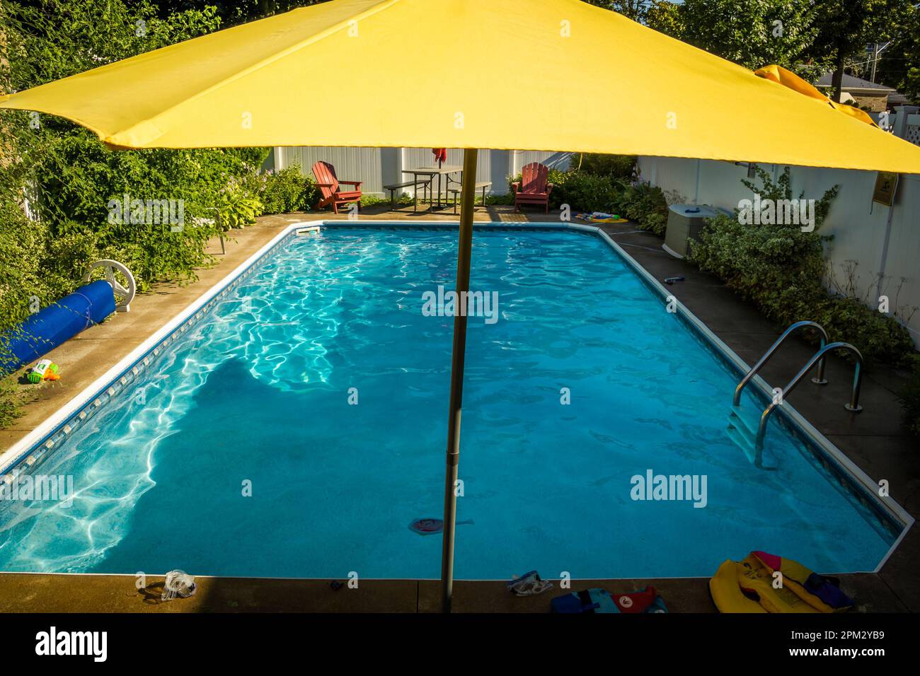 Large yellow umbrella facing an indoor water filled pool Stock Photo ...