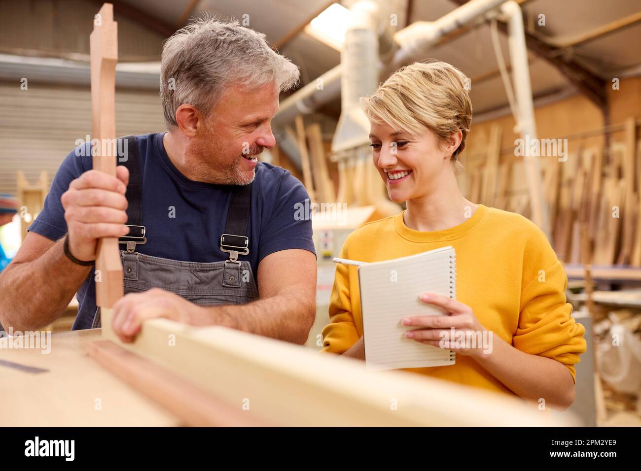 Female Apprentice Learning Skills From Mature Male Carpenter In ...
