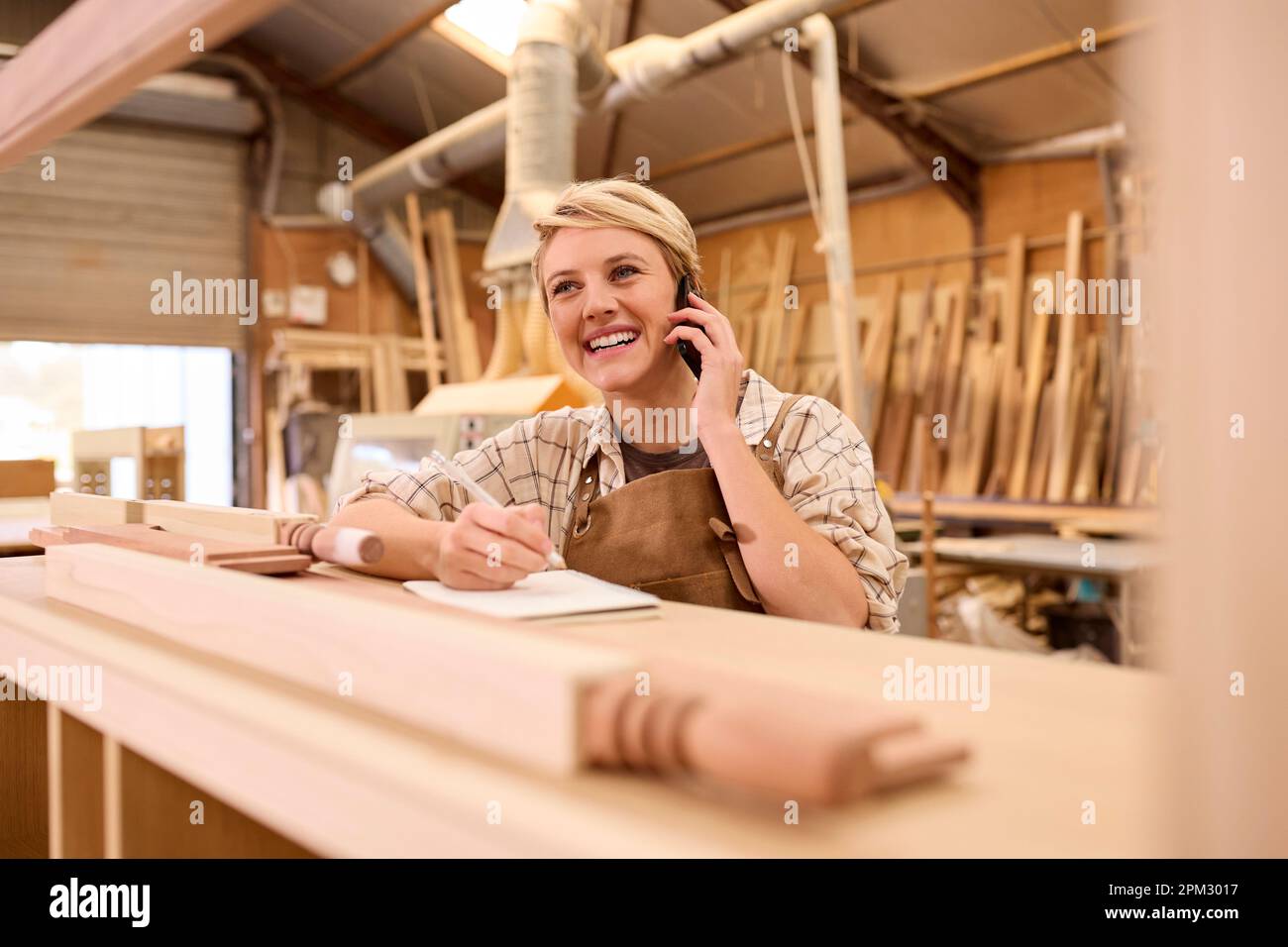 Female Apprentice Working As Carpenter In Furniture Workshop Making ...