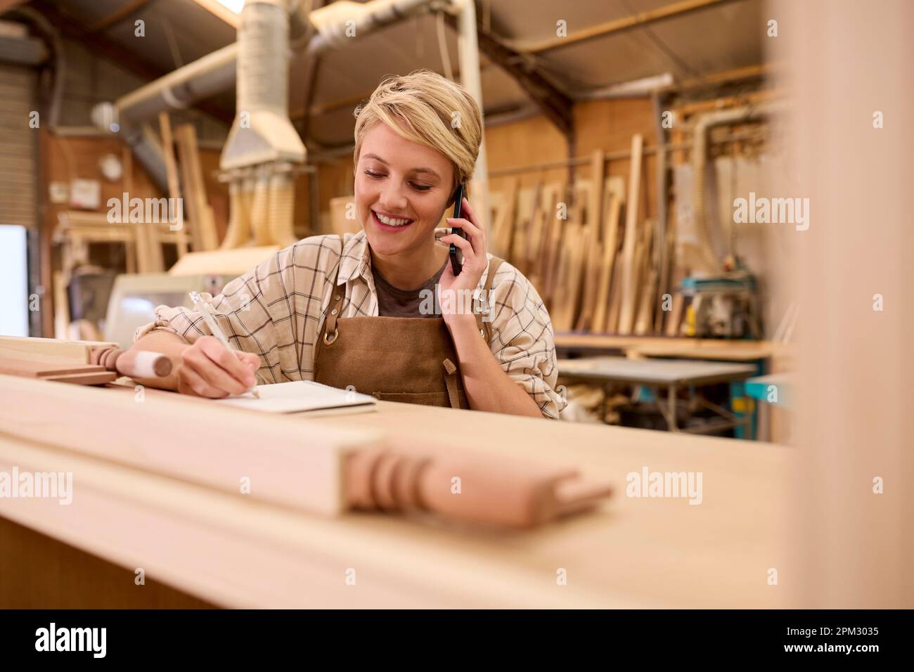 Female Apprentice Working As Carpenter In Furniture Workshop Making ...