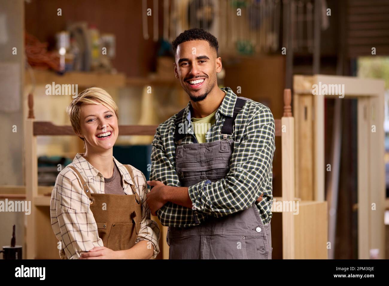 Portrait Of Male And Female Apprentices Working As Carpenters In ...