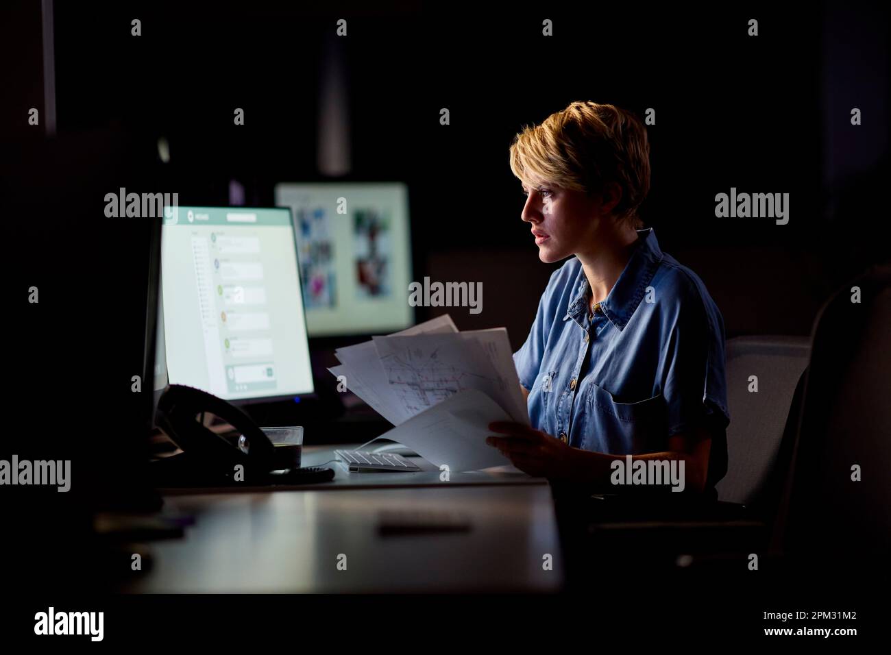 Businesswoman Working Late In Office With Face Illuminated By Computer ...