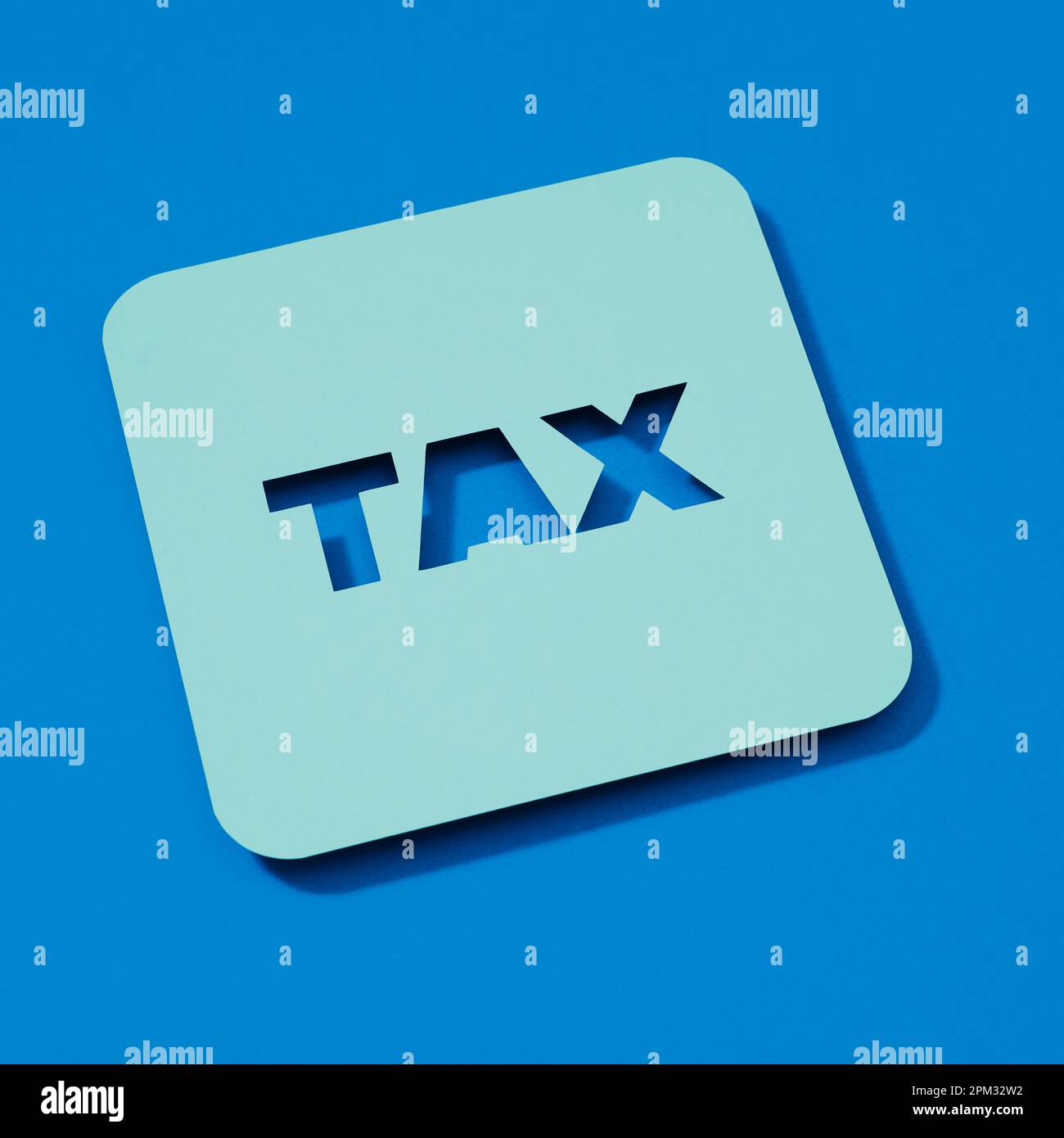 the text tax cut out in a pale blue sign against a darker blue ...