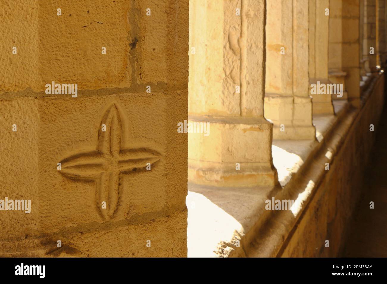 Cross carved into a stone pillar in the Cloisters of the Cathedral ...