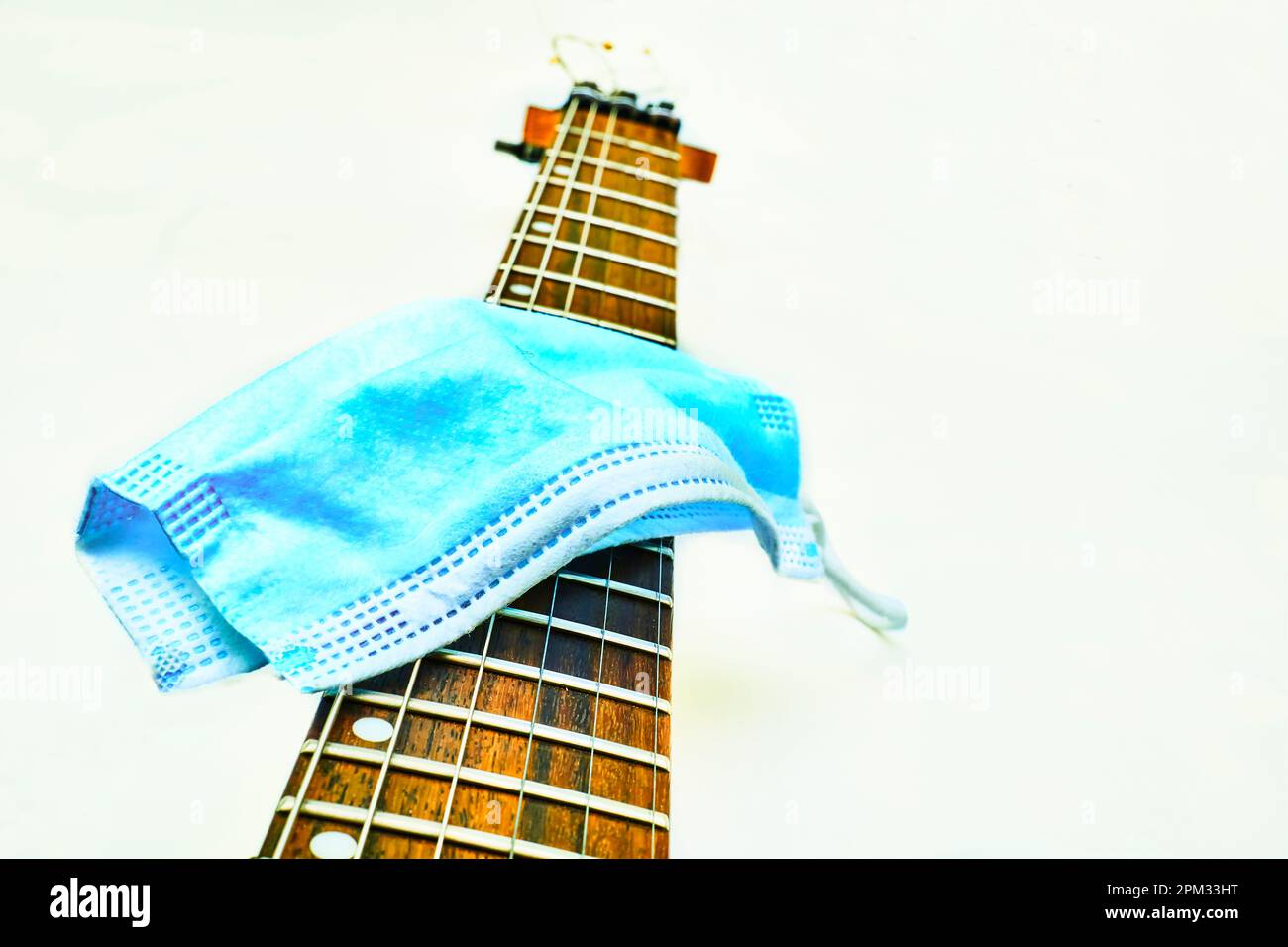 Blue protective mask on the fretboard of a black electric guitar Stock ...