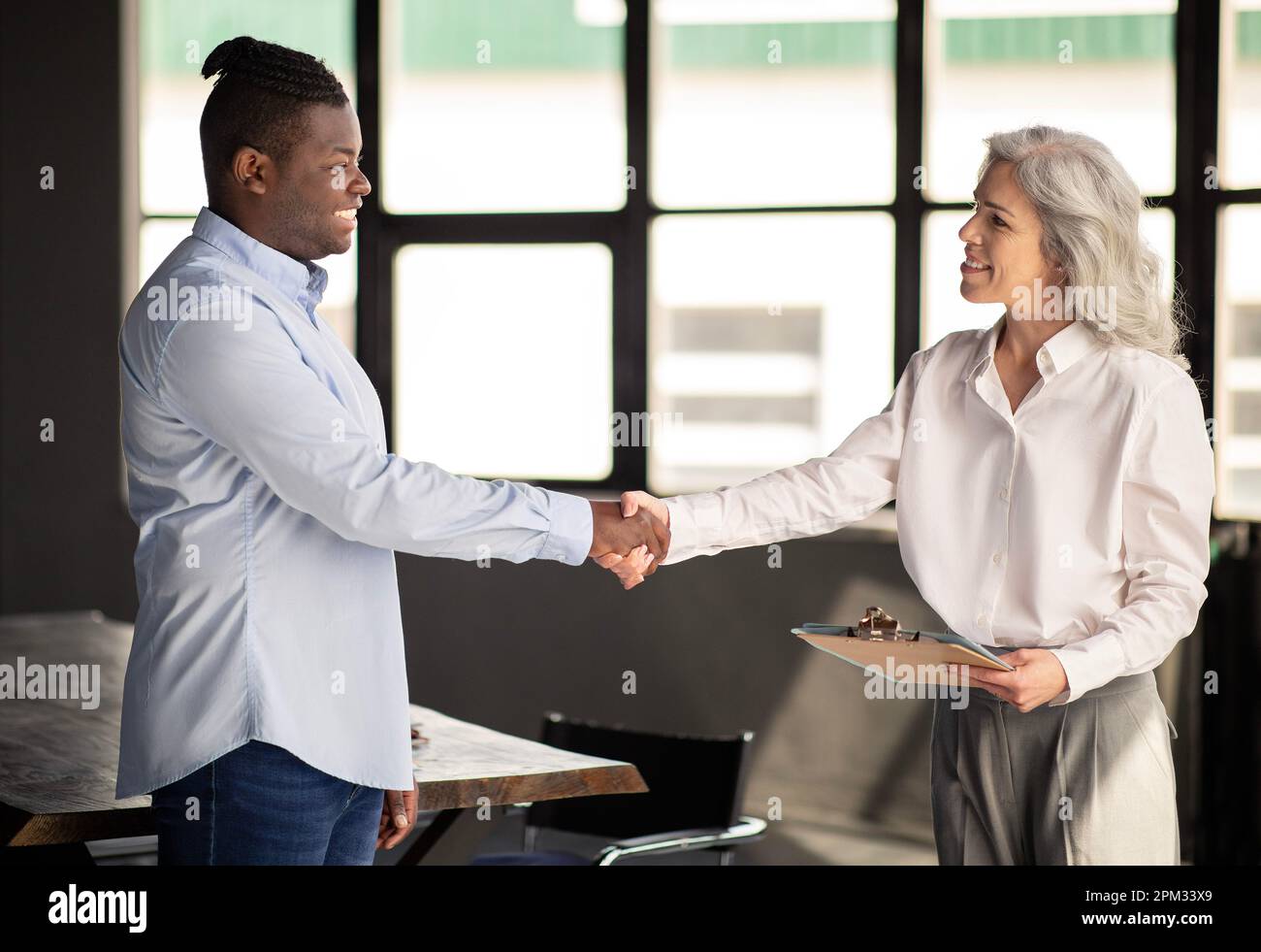 HR Manager Lady Shaking Hands With New Employee In Office Stock Photo ...