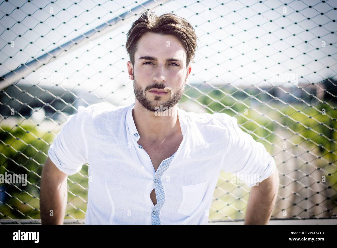 One handsome young man in city setting Stock Photo - Alamy