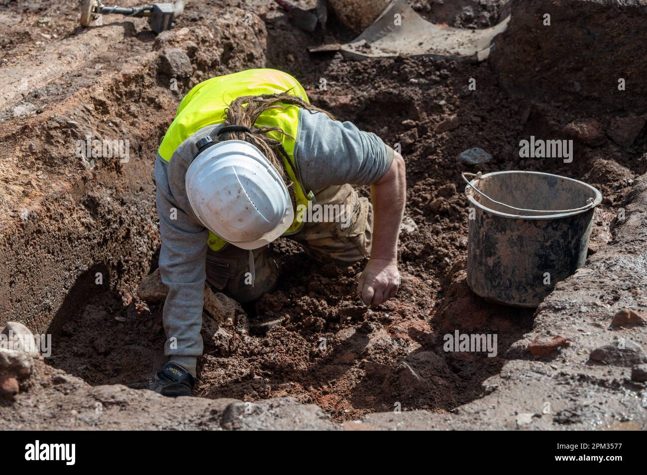 Trier, Germany. 11th Apr, 2023. A man digs at an archaeological site ...
