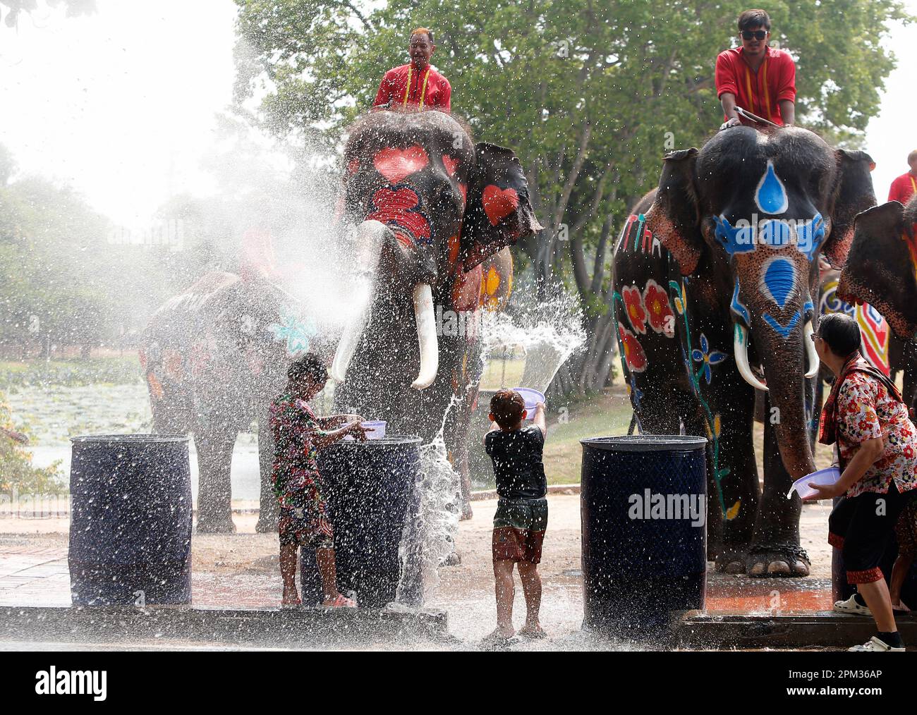 Ayutthaya, Thailand. 11th Apr, 2023. Elephants splash children with water in celebration of the ...