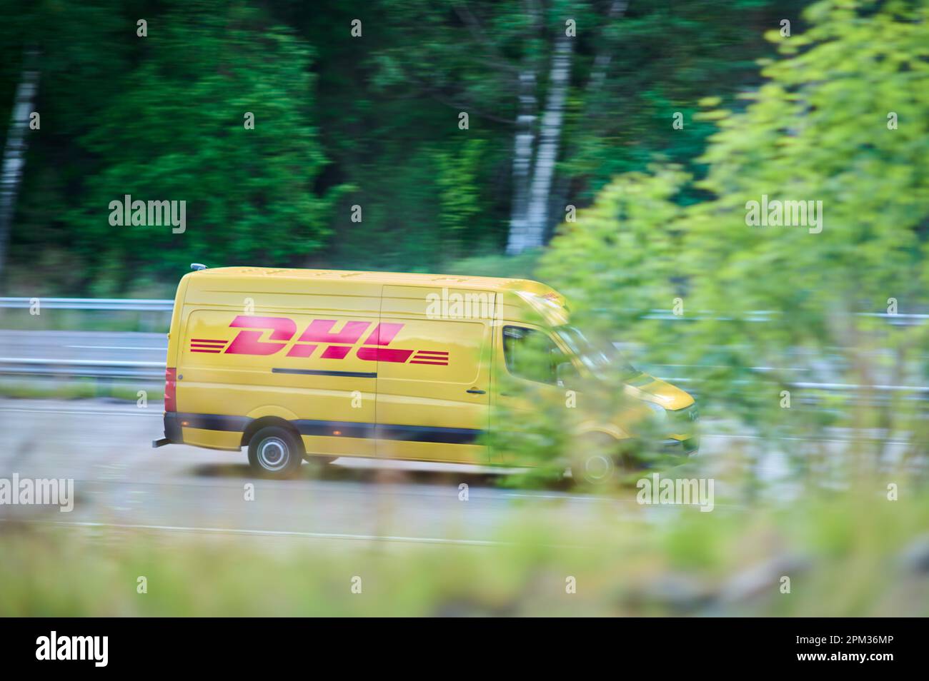 A DHL Transporter Van driving on a highway Stock Photo - Alamy