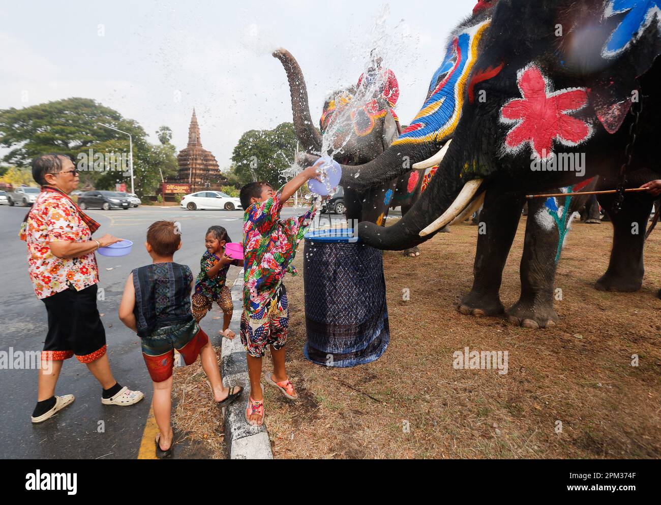Ayutthaya, Thailand. 11th Apr, 2023. Elephants splash children with water in celebration of the ...
