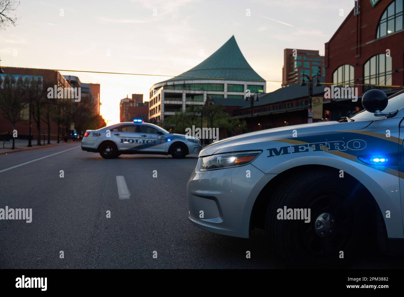 Police cars and cordon tape block Main Street near the Old National ...