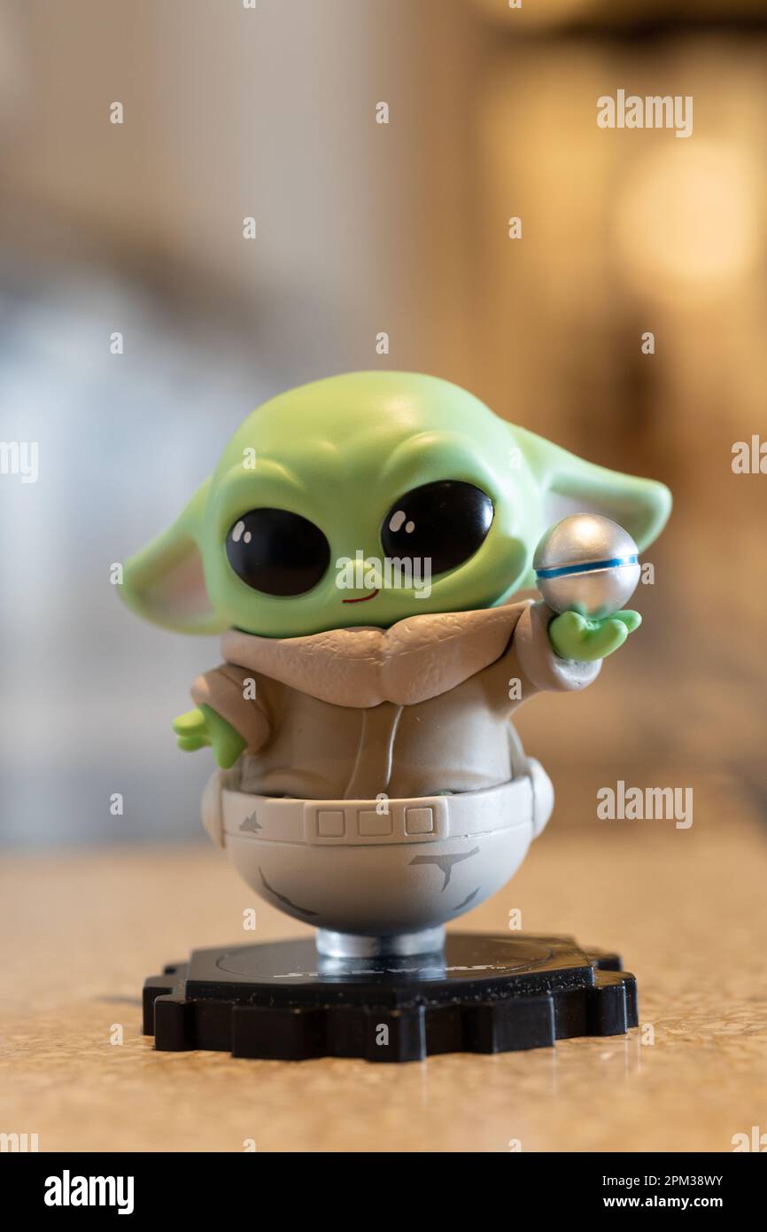 A vertical shallow focus shot of adorable Grogu figurine from The ...
