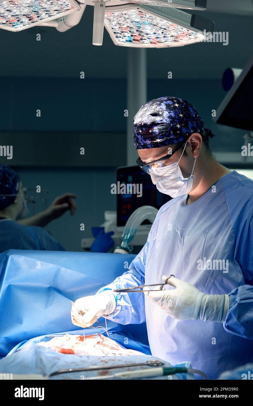 Portrait of a male surgeon in the operating room on the background of ...