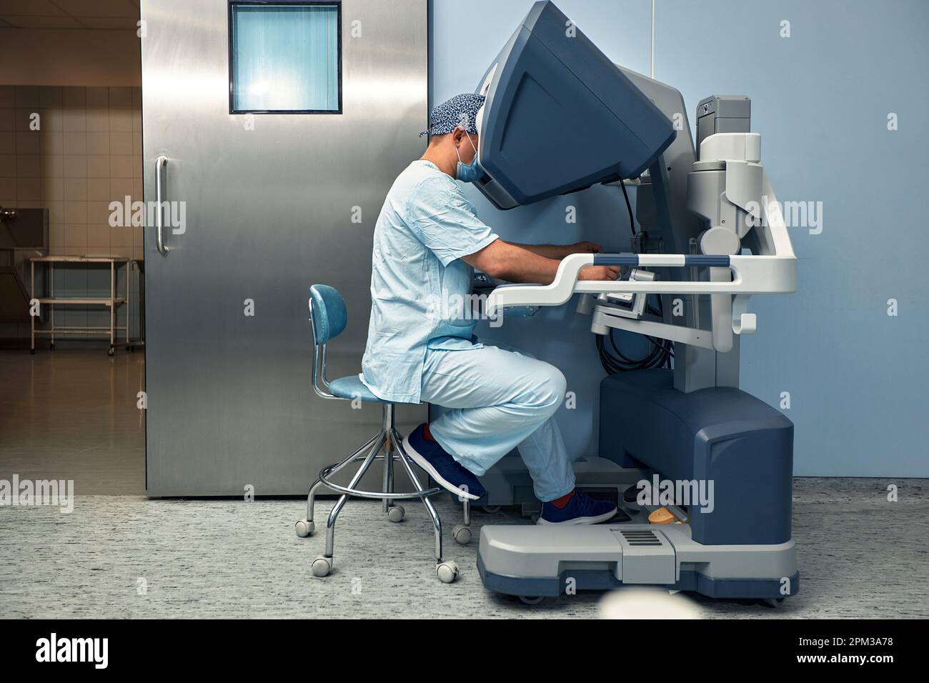 The surgeon is at the computer robot in a special control module, the ...