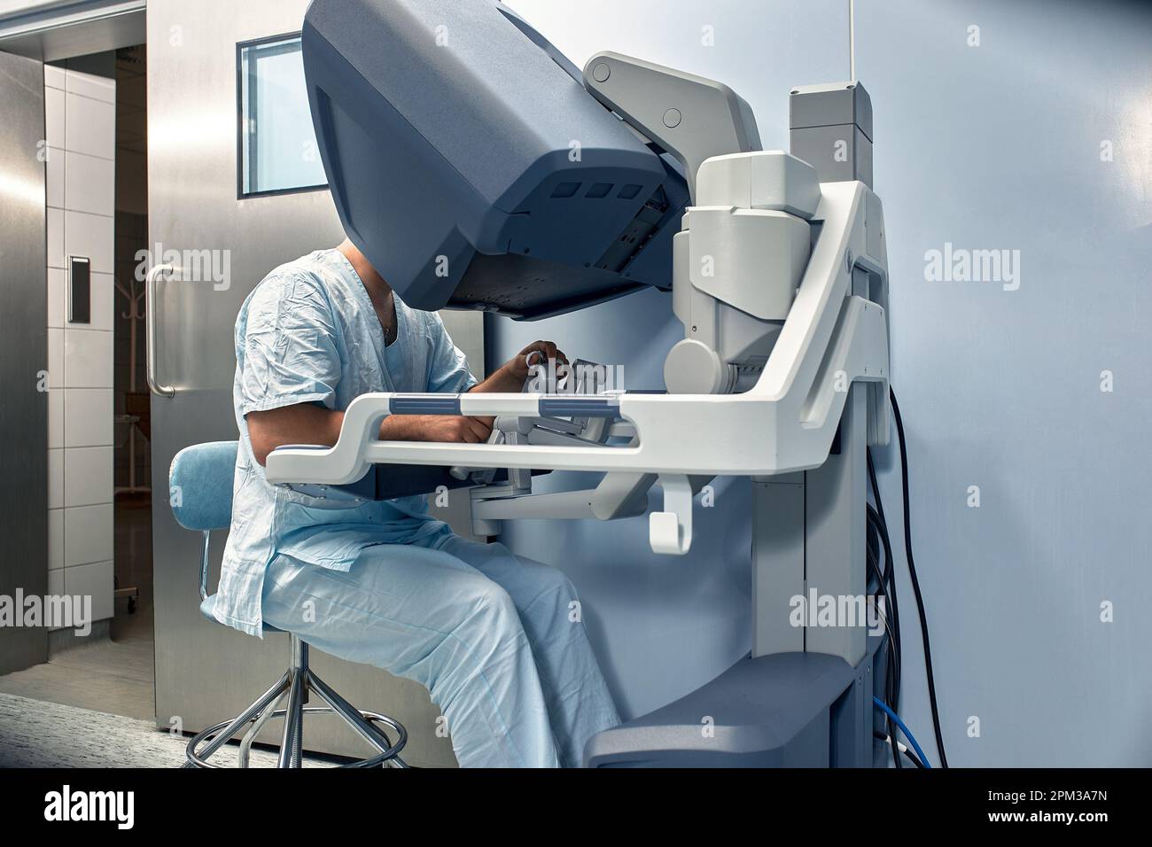 The surgeon is at the computer robot in a special control module, the ...