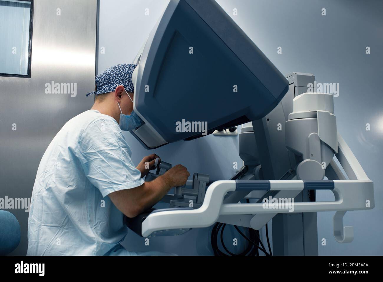 The surgeon is at the computer robot in a special control module, the ...
