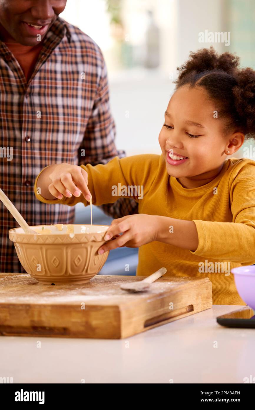 Family Shot With Father And Daughter Baking At Home In Kitchen Mixing ...