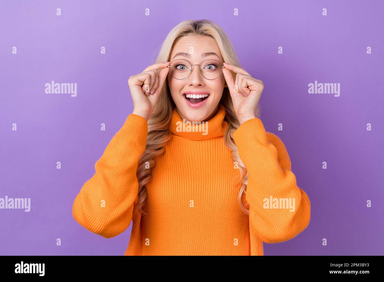 Portrait of astonished positive girl hands touch glasses open mouth ...