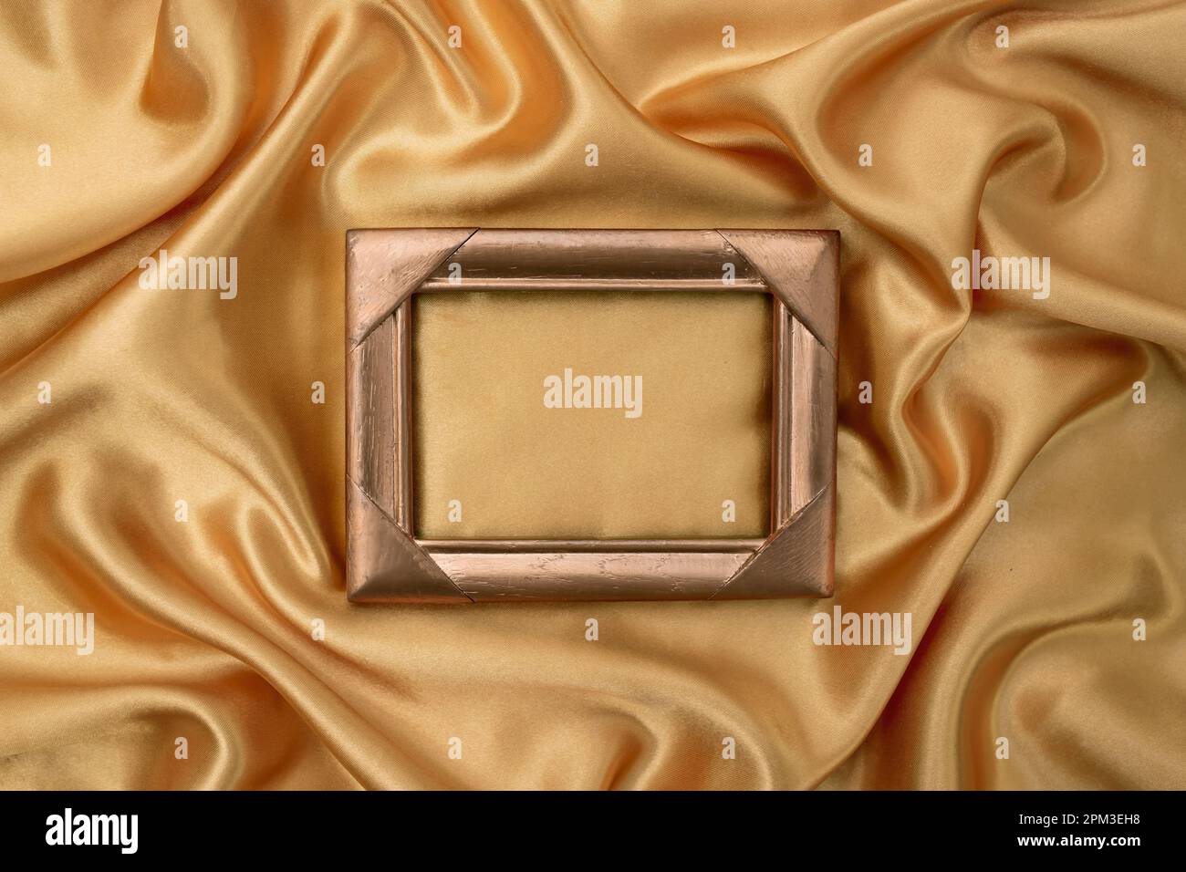 Ochre satin fabric with folds and a golden rectangular frame, abstract ...