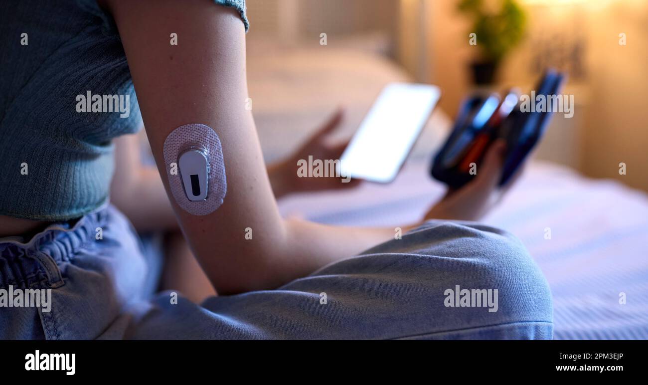Close Up Of Diabetic Girl Sitting On Bed At Home Checking Insulin ...