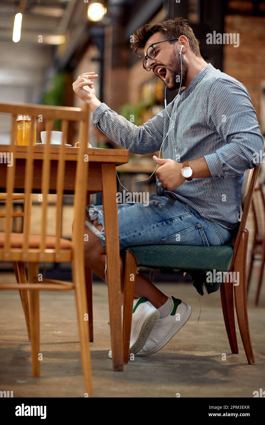 Happy young hipster man dancing hi-res stock photography and images - Alamy